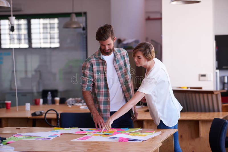 Making the Project Work for Them. a Young Woman Looking at Sticky Notes ...