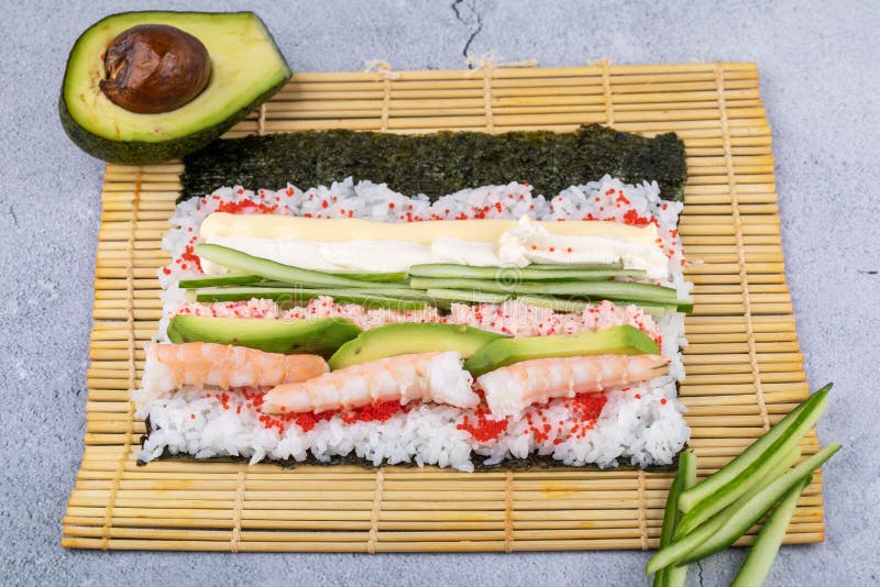 Making Rolled Sushi in a Bamboo Sushi Mat Stock Photo - Image of bamboo ...
