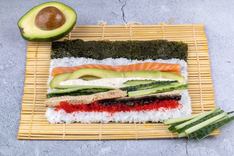Making Rolled Sushi in a Bamboo Sushi Mat Stock Photo - Image of food ...
