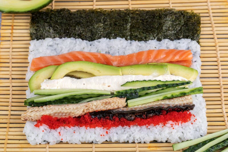 Making Rolled Sushi in a Bamboo Sushi Mat Stock Photo - Image of ...