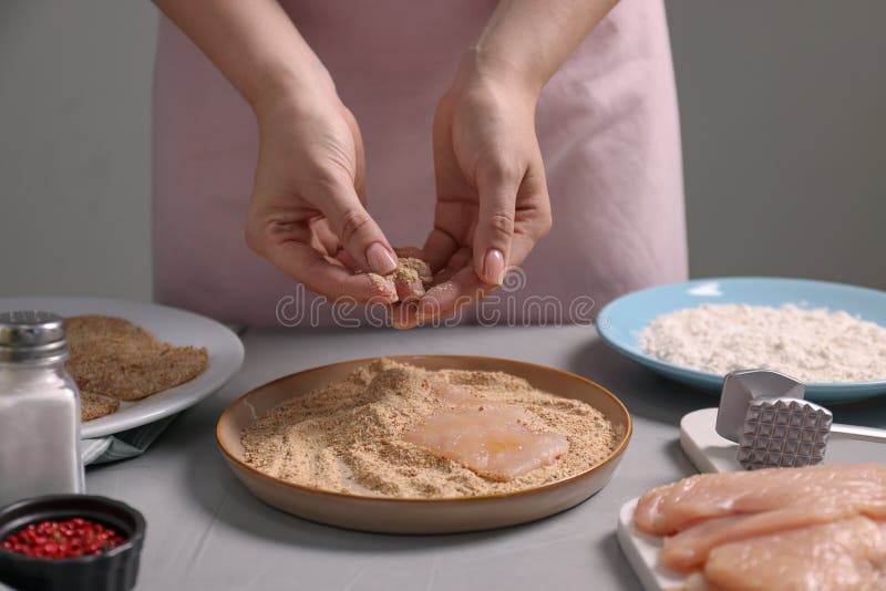Making Schnitzel. Woman Coating Slice of Meat with Bread Crumbs at Grey ...