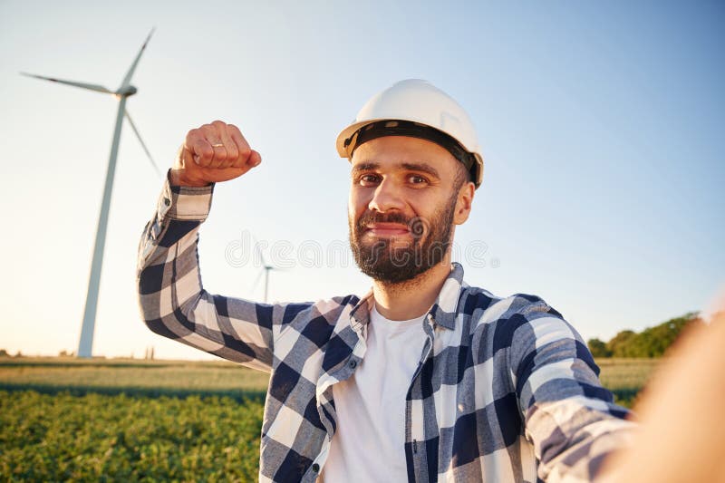 With Notepad. Service Engineer is on the Field with Windmills Stock ...