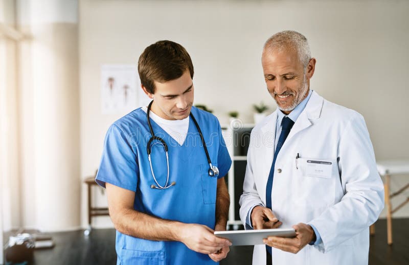 Making Smart Decisions with Smart Tech. Two Medical Practitioners Using ...