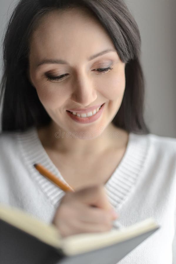 Making Some Notes. Beautiful Middle-aged Woman Writing Something Stock ...