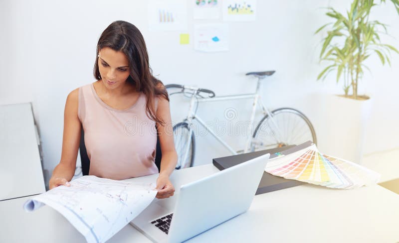 Making Sure the Plans are in Order. a Young Architect Looking Over Some ...