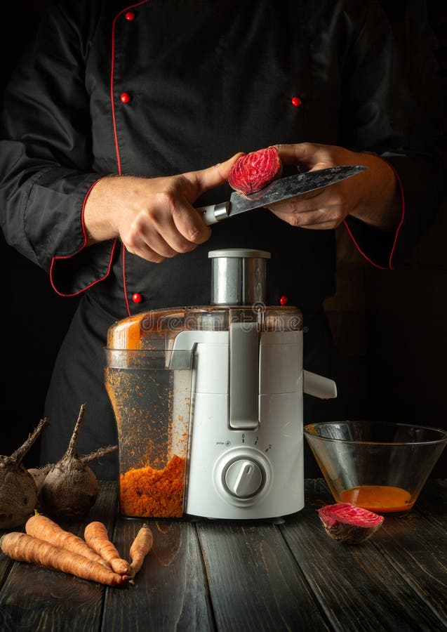 Making Vegetable Juice with a Juicer. Chef Cutting Red Beetroot with a ...