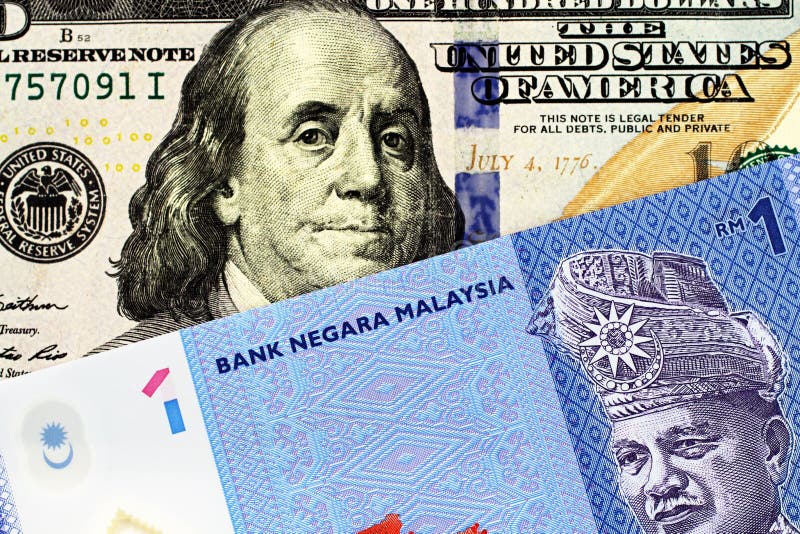 A Malaysian One Ringgit Bill with an American One Hundred Dollar Bill ...