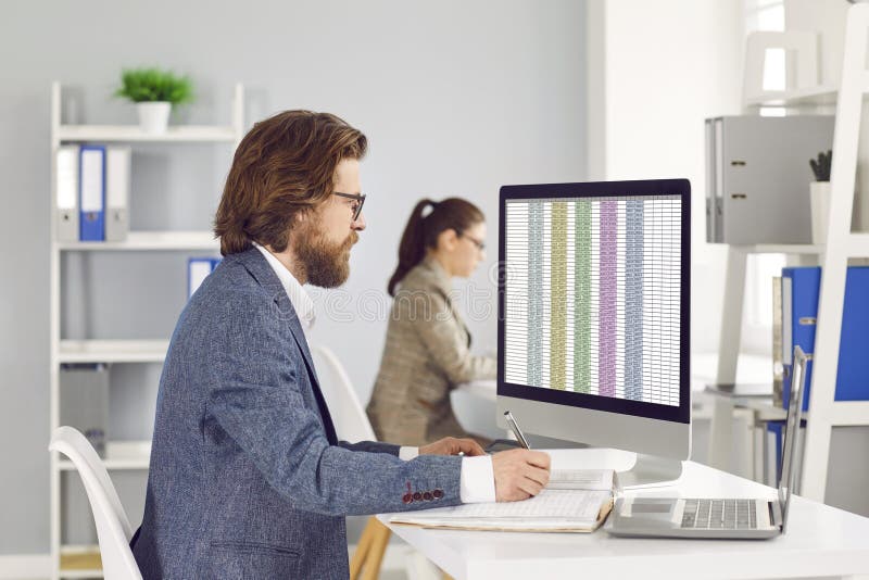 Male Accountant in Office Working Using Accounting Report Spreadsheet ...