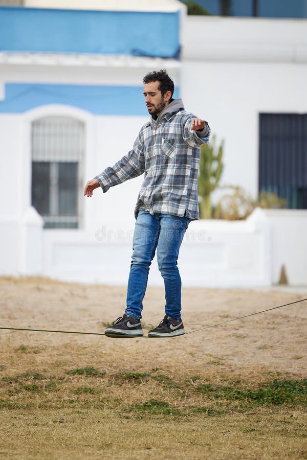Male Acrobat Balances Standing on a Rope Editorial Photography - Image ...