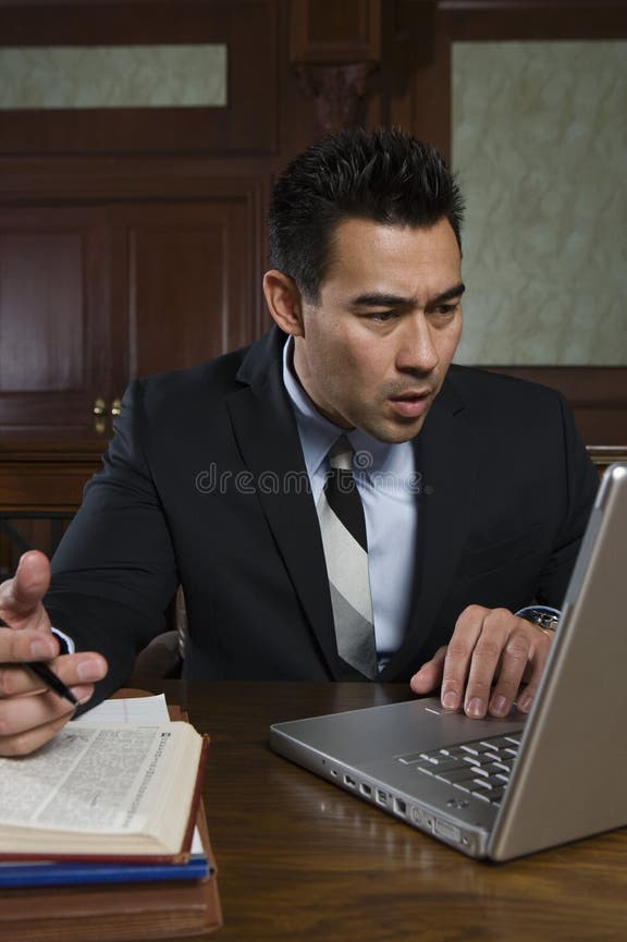 Male Advocate Using Laptop stock photo. Image of indoors - 29663012