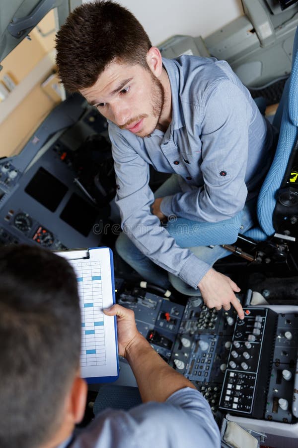 Male Aero Engineer with Clipboard Working in Cockpit Stock Photo ...