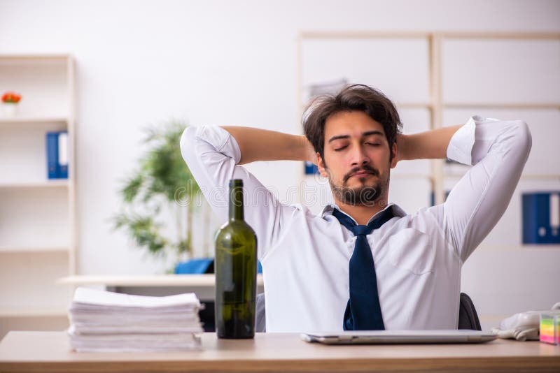 Young Alcohol Addicted Employee Sitting in the Office Stock Photo ...