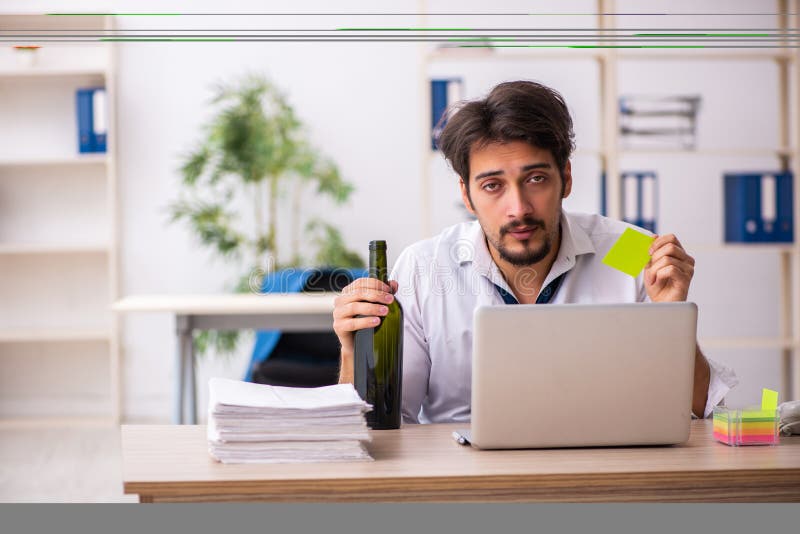 Young Alcohol Addicted Employee Sitting in the Office Stock Photo ...
