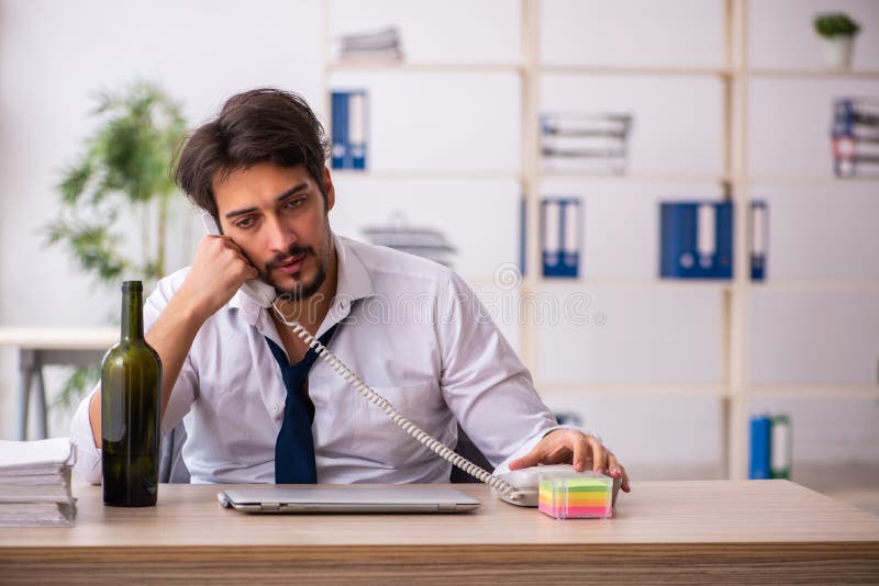 Young Alcohol Addicted Employee Sitting in the Office Stock Image ...