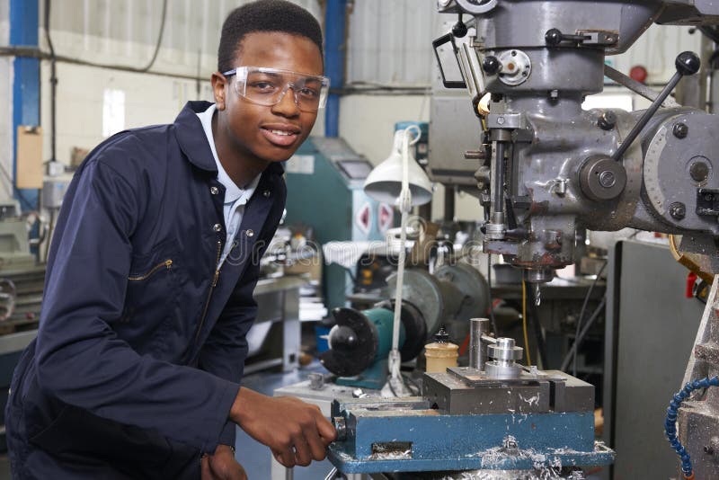 Male Apprentice Engineer Working on Drill in Factory Stock Photo ...