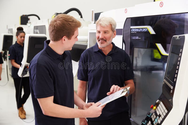 Engineer Planning Project with CNC Machinery in Background Stock Image ...