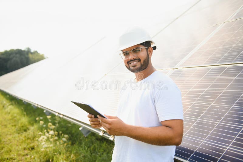 Male Arab Engineer Standing on Field with Rows of Solar Panels Stock ...