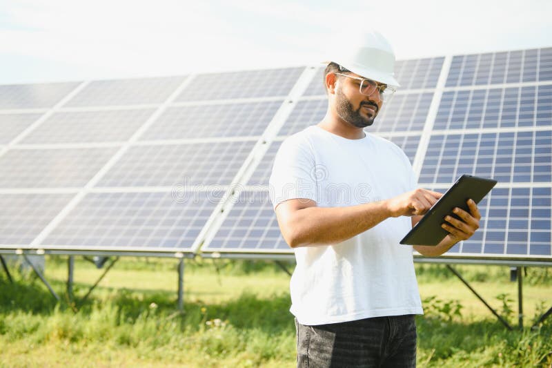 Male Arab Engineer Standing on Field with Rows of Solar Panels Stock ...