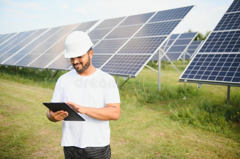 Male Arab Engineer Standing on Field with Rows of Solar Panels Stock ...