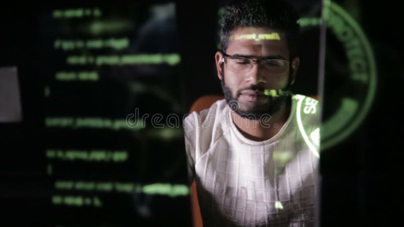 Male Arabic Hacker Hacks Computer in Dark. Computer Code Reflecting on ...