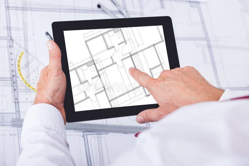 Male Architect With Digital Tablet Studying Plans In Office Stock Photo ... Male Architect With Digital Tablet Studying Plans In Office Stock Photo ...