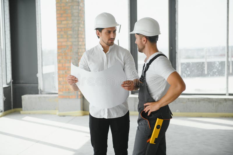 Male Architect Giving Instructions To His Foreman at Construction Site ...
