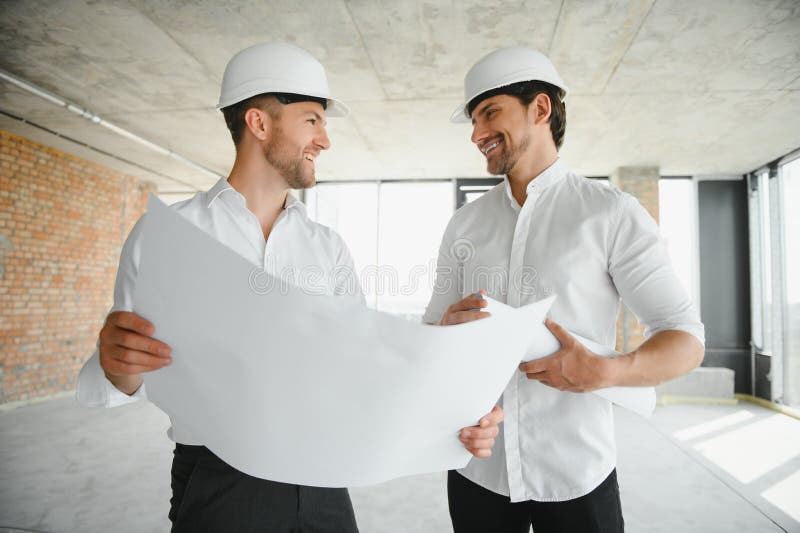 Male Architect Giving Instructions To His Foreman at Construction Site ... Male Architect Giving Instructions To His Foreman at Construction Site ...