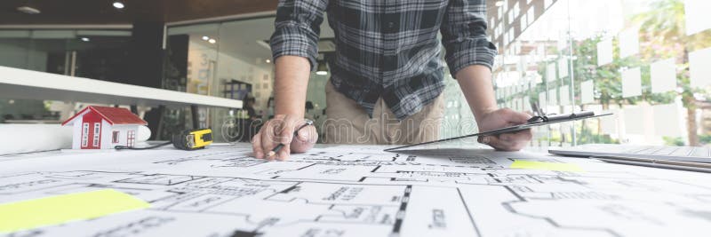 A Male Architect Measuring and Marking the Scale Ratio of Sizes of a ...