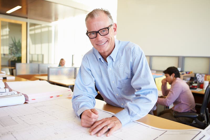 Male Architect with Digital Tablet Studying Plans in Office Stock Photo ... Male Architect with Digital Tablet Studying Plans in Office Stock Photo ...