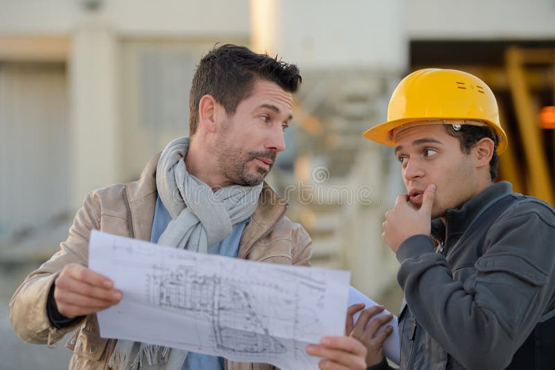 Male Architect with Worker Discussing at Construction Site Stock Photo ...