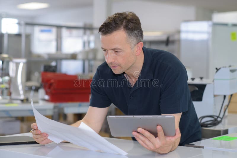 Male Architect Working with Blueprints and Digital Tablet Stock Photo ... Male Architect Working with Blueprints and Digital Tablet Stock Photo ...