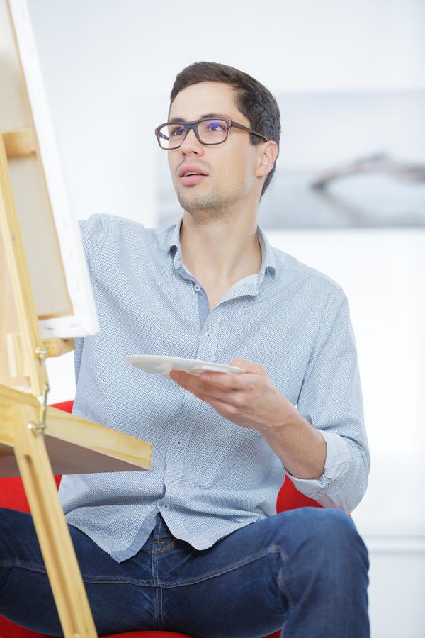 Male Artist Paints on Easel in Workshop Stock Photo - Image of work ...