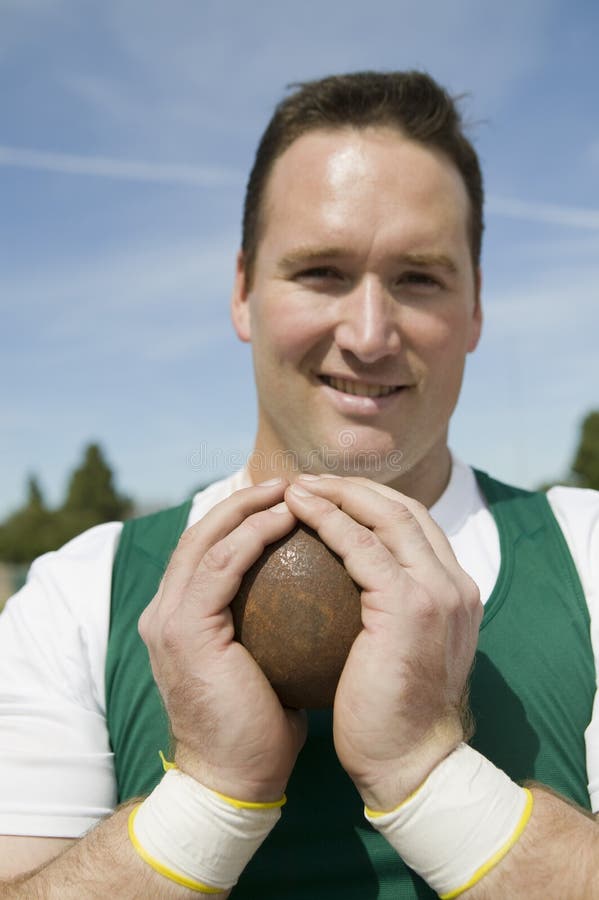 Male Athlete Holding Shot Put Stock Image - Image of event, adult: 29654987