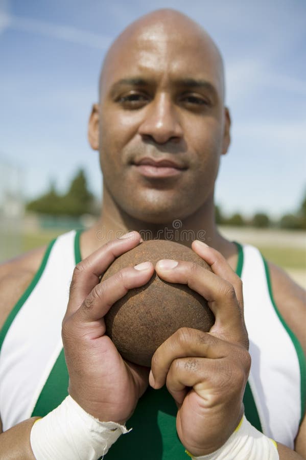 Man Holding Shot Put Against Sky Stock Image - Image of holding ...