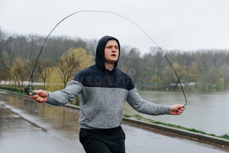 Male Athlete Jumping Rope Outdoors on a Rainy Day Stock Photo - Image ...