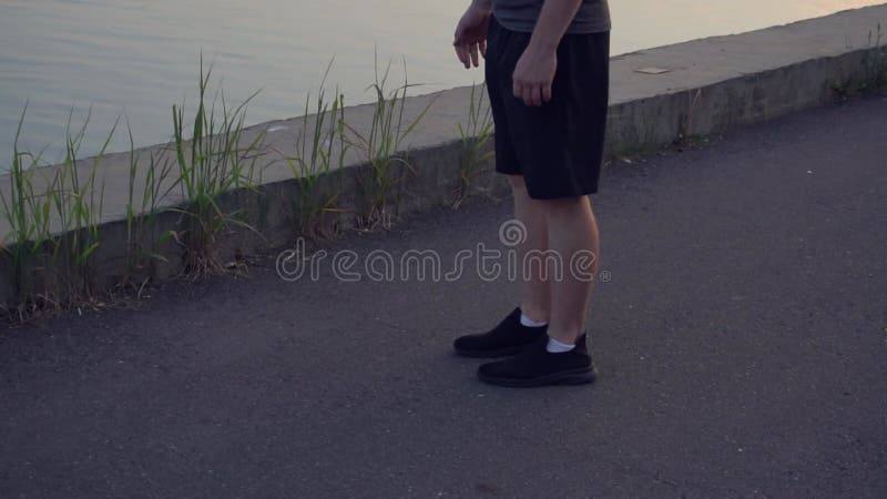 Male Athlete Performs a Stretching Exercise, Pulls His Leg with His ...