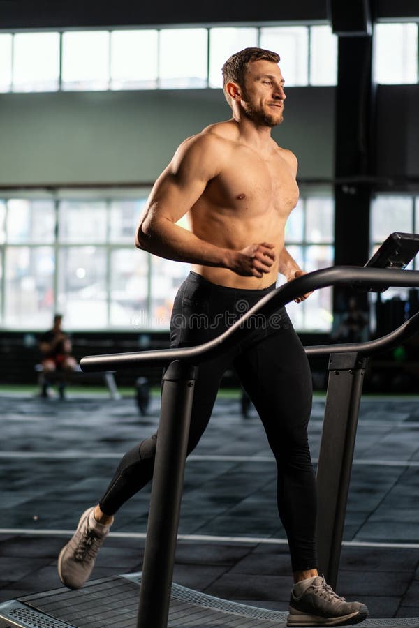 Male Athlete Running on a Treadmill in the Gym Stock Image - Image of ...