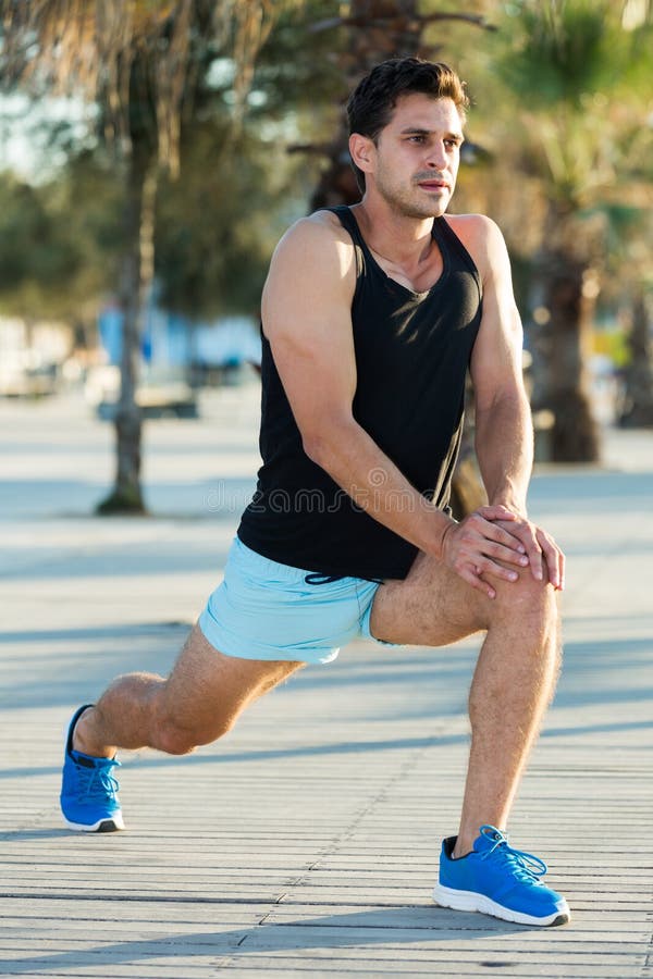 Male Athlete Stretching Legs Stock Photo - Image of pastime ...