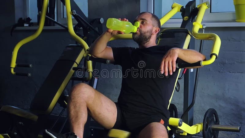 Male Athlete Using Exercise Machine during Strength Training in Gym ...