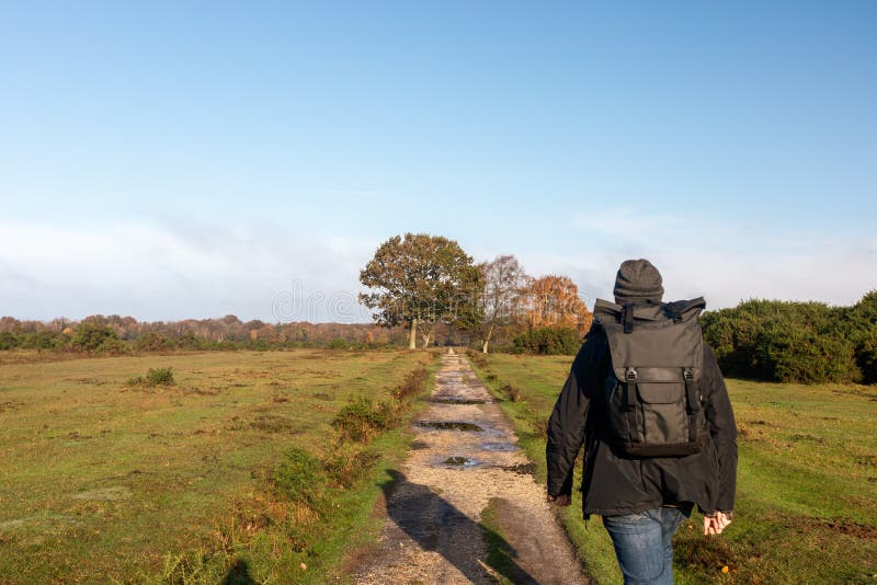 Male With A Backpack Walking Through The Path In The Valley Stock Photo ...
