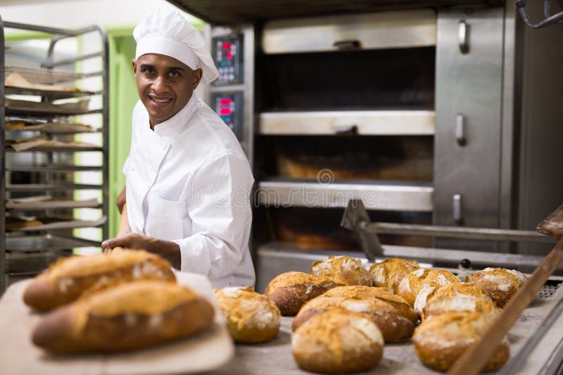 Male Baker with Bread on Baking Shovel in Kitchen Stock Image - Image ...