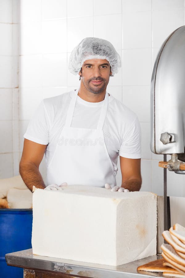 Male Baker with Bread Loaf at Cutting Machine in Bakery Stock Image ...