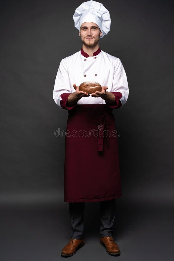 Male Baker Holding Bread Loaf and Looking at Camera Isolated on Black ...