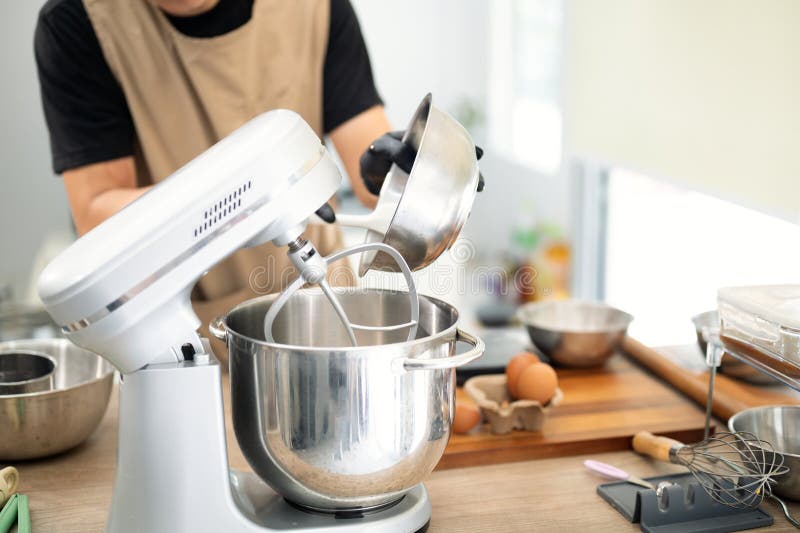 Male Baker Pouring Ingredients into a Stand Mixer for Cookie Dough ...