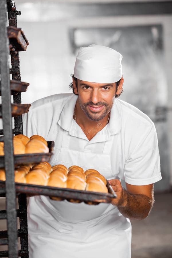 Male Baker Removing Baking Tray from Rack Stock Image - Image of ...