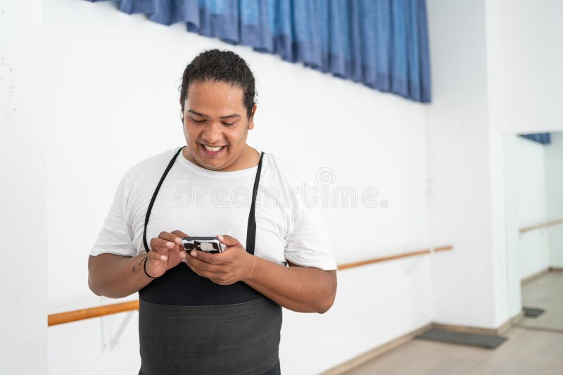 Male Ballet Dancer Smiling Using a Phone in a Ballet Dance Studio Stock ...