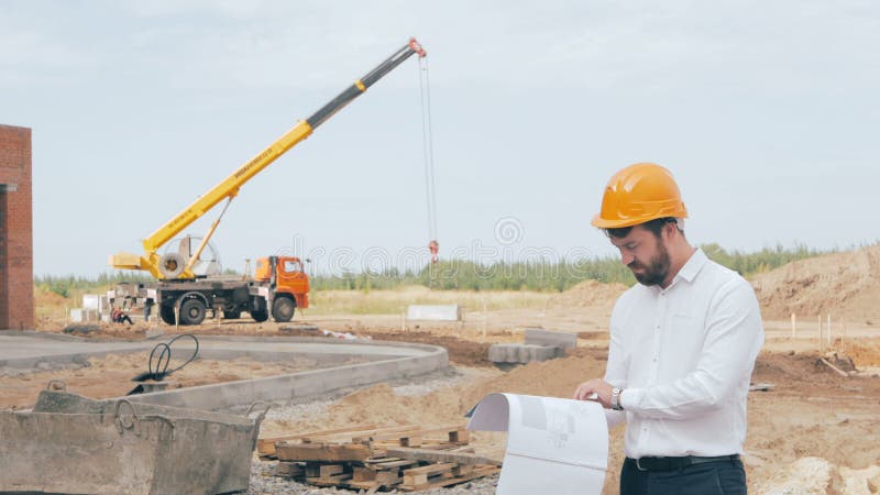 Male Bearded Construction Boss Dressed in a Hard Hat Controls ...
