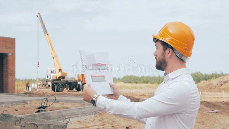 Male Bearded Construction Boss Dressed in a Hard Hat Controls ...