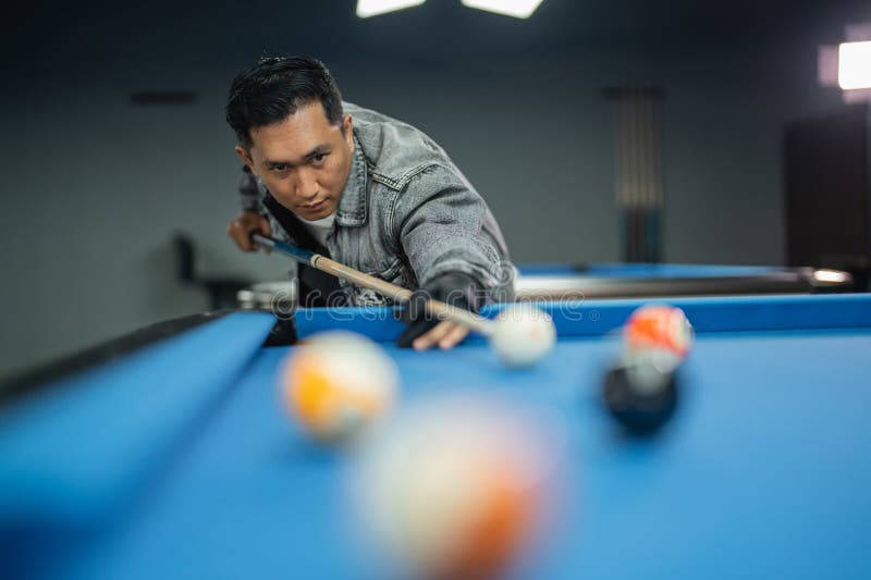 Male Billiard Player Poking the Ball Seriously Using the Cue Stick ...