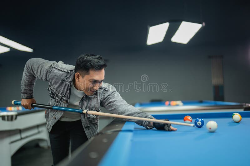 Male Billiard Player Poking the Ball Seriously Using the Cue Stick ...